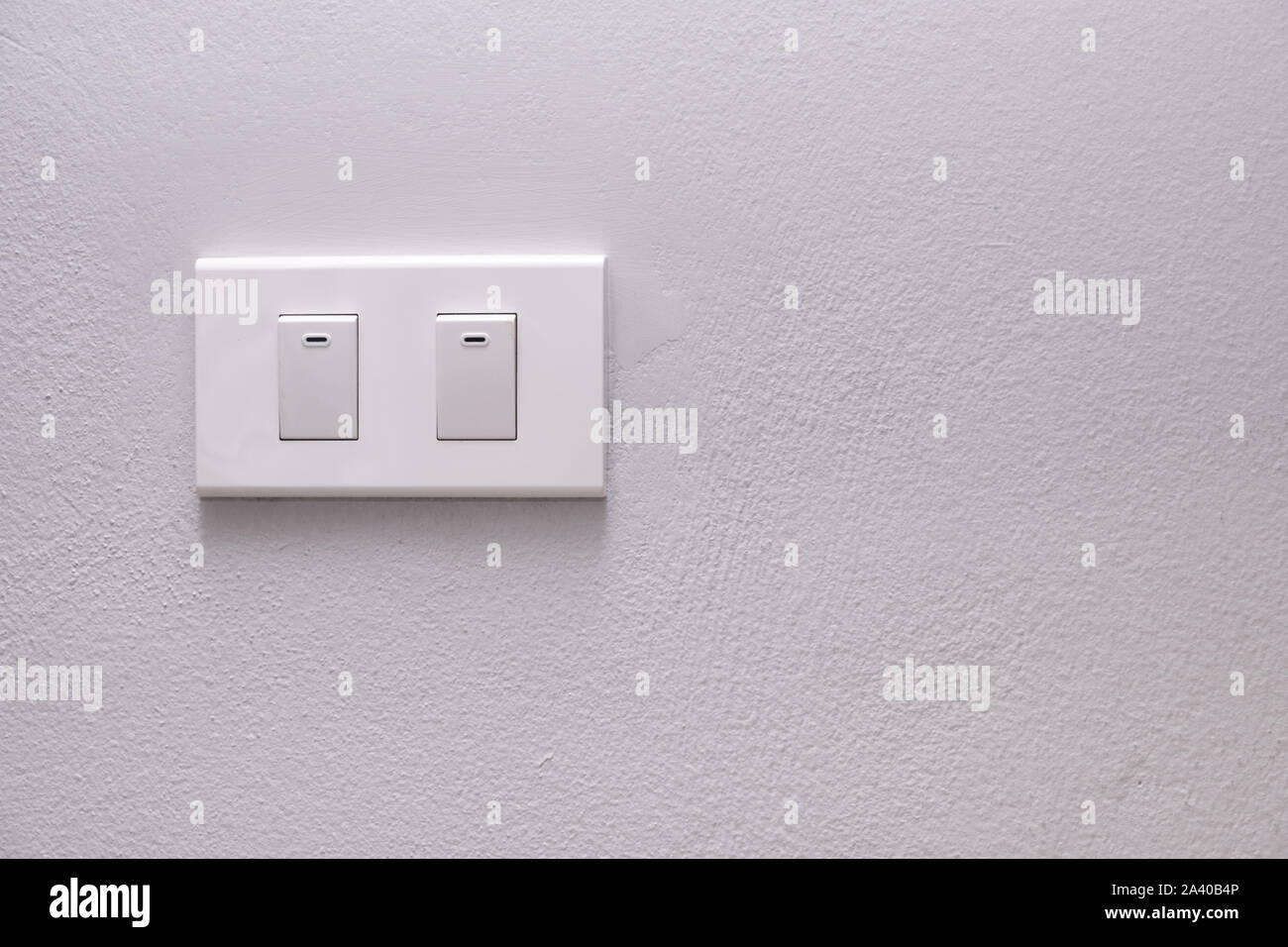 White electricity switch or lamp switch on white wall Stock Photo - Alamy