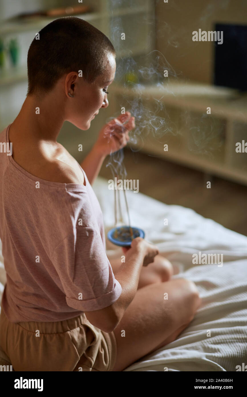 Young woman smoking bed hi-res stock photography and images - Alamy