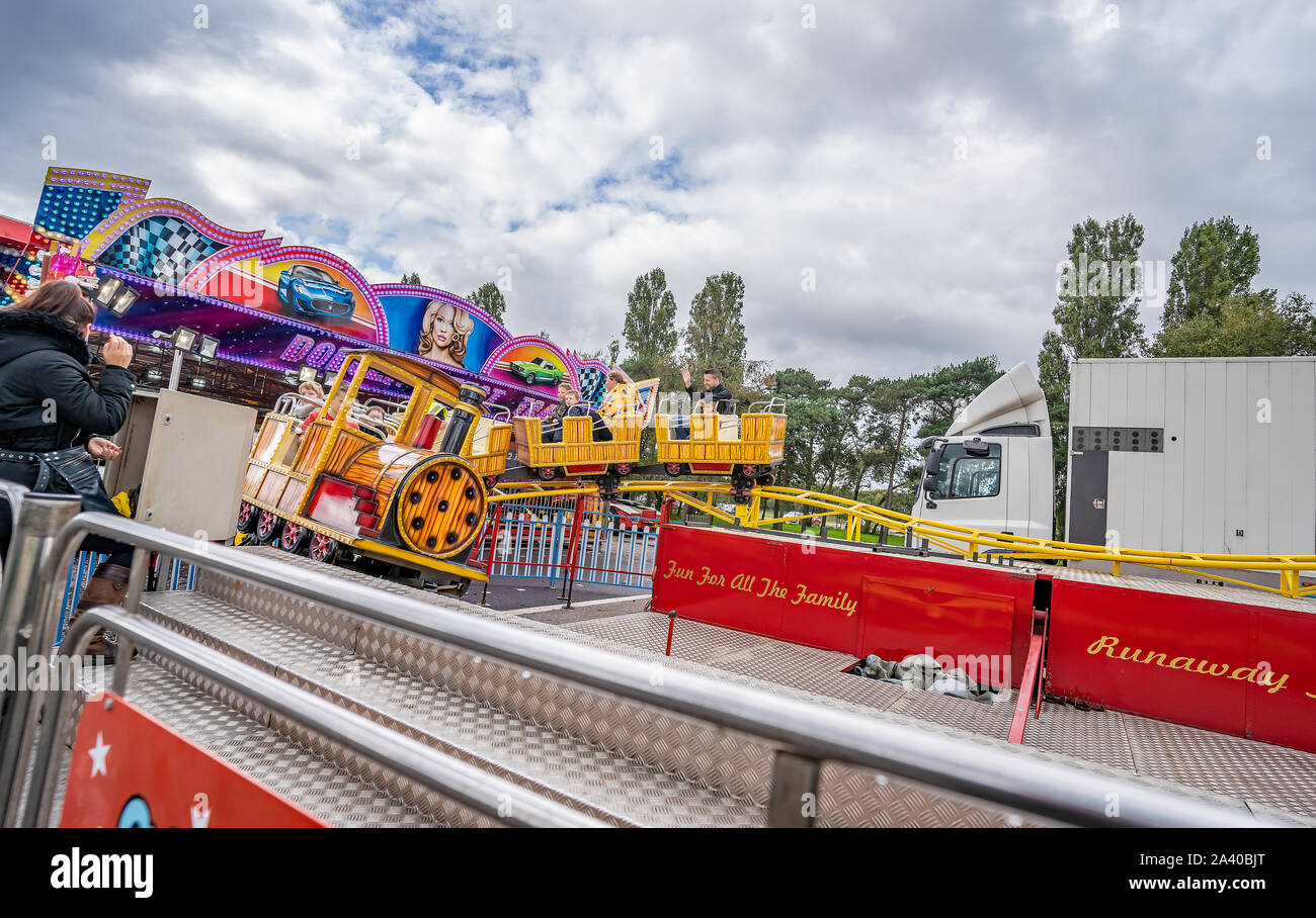 Small rollercoaster ride at the funfair Stock Photo - Alamy