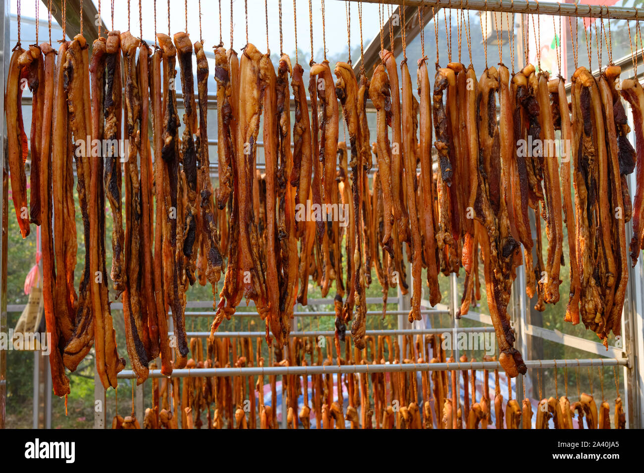 air-dried bacon hanging on shelf and being dried Stock Photo - Alamy
