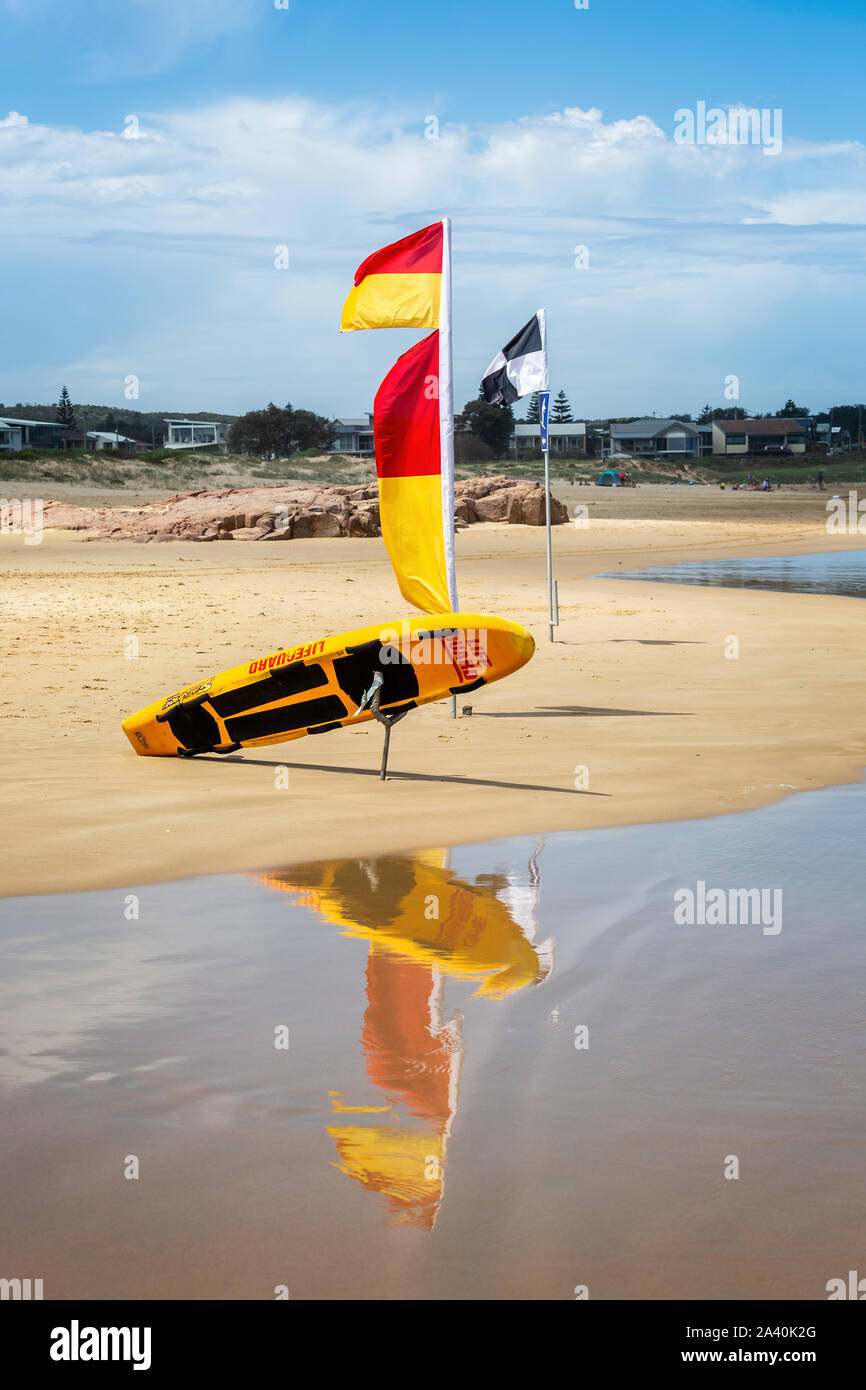 Lifesaving flag and surf board on Birubi Beach, NSW, Australia on 8 ...