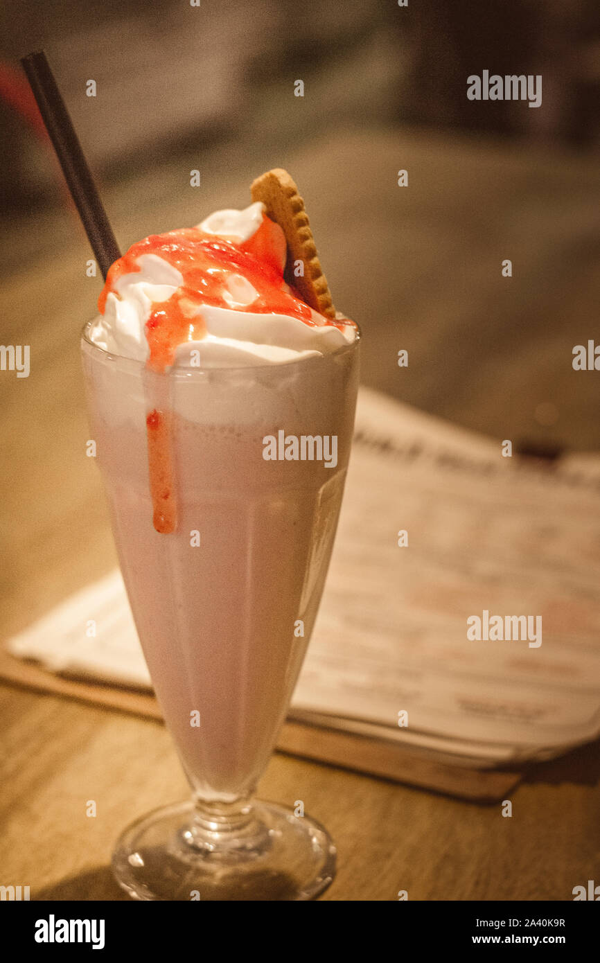 Nutty caramel shake with whipped cream and biscuit hi-res stock ...