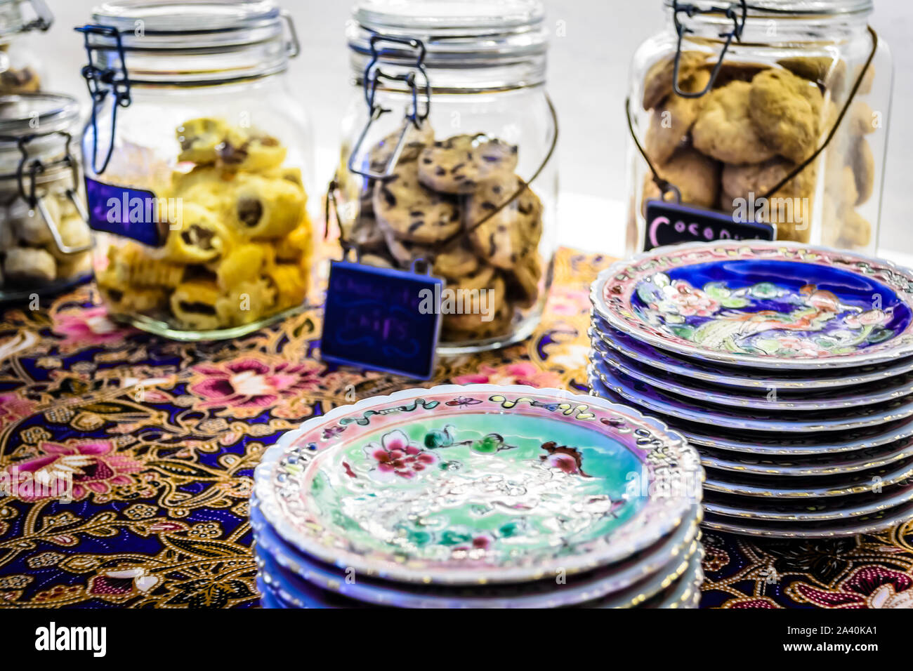 colourful peranakan small dishes on a colourful batik table cloth with ...