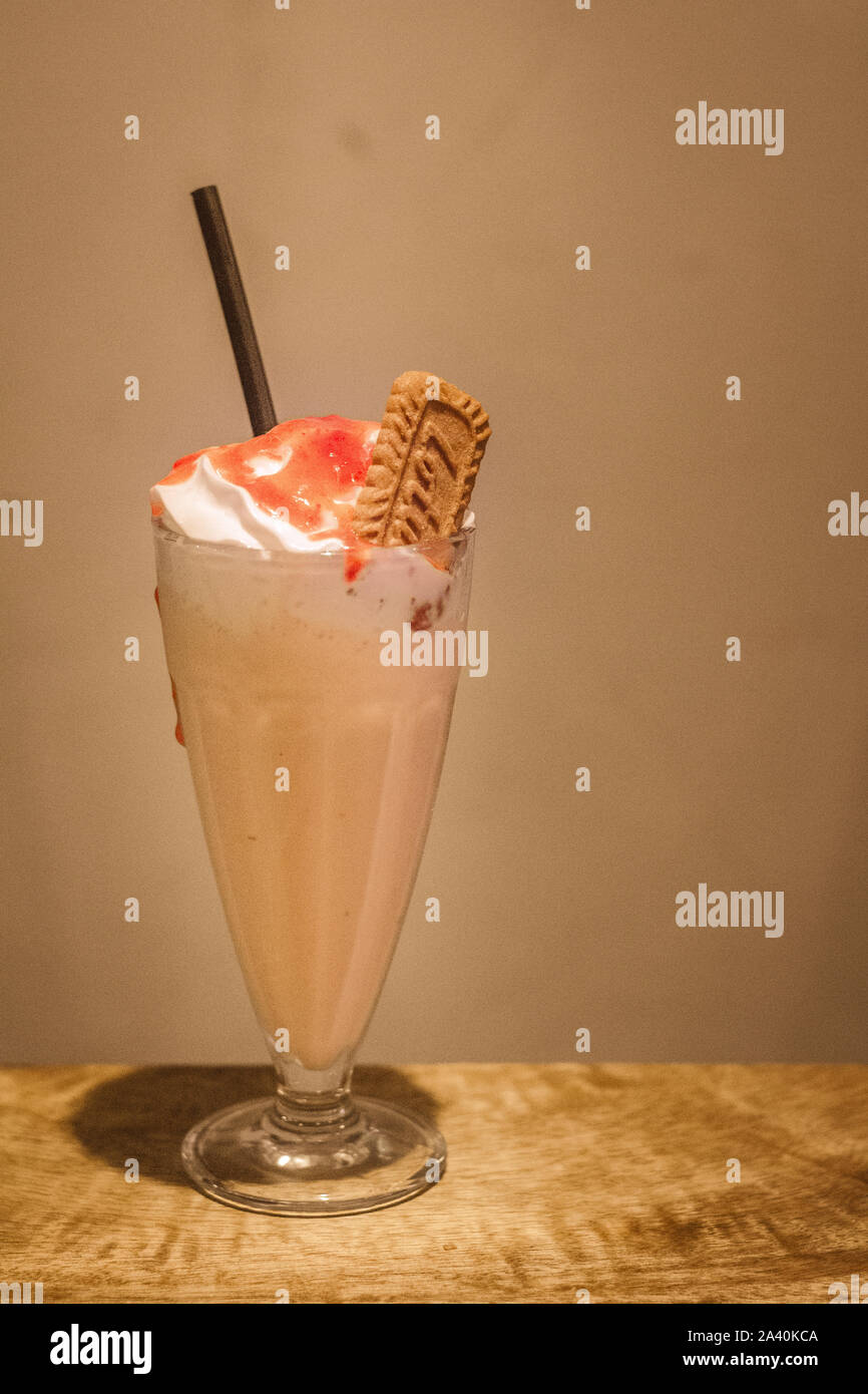 Nutty caramel shake with whipped cream and biscuit hi-res stock ...