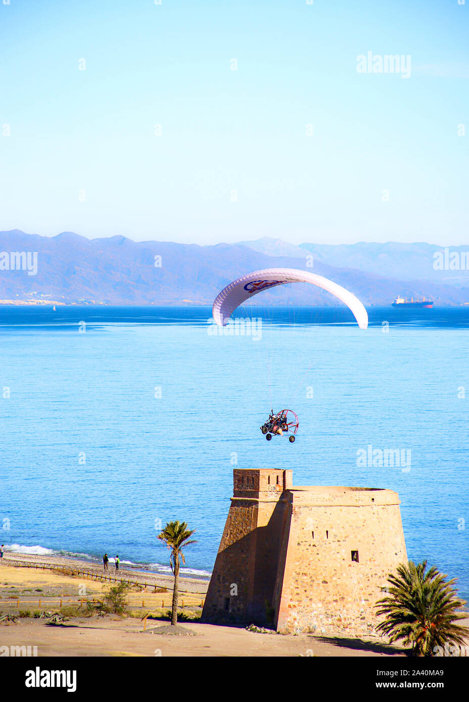 Paragliding over a Crystal Blue Sea Stock Photo - Alamy
