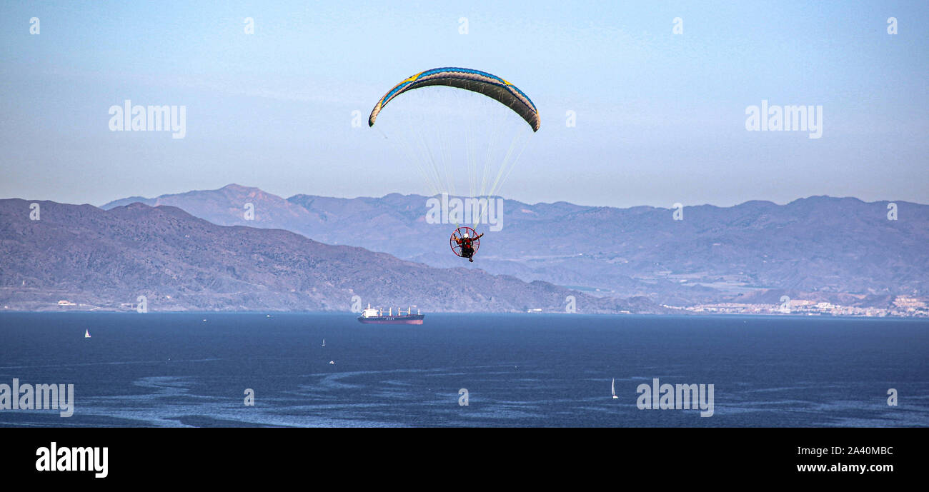 Paragliding over a Crystal Blue Sea Stock Photo - Alamy