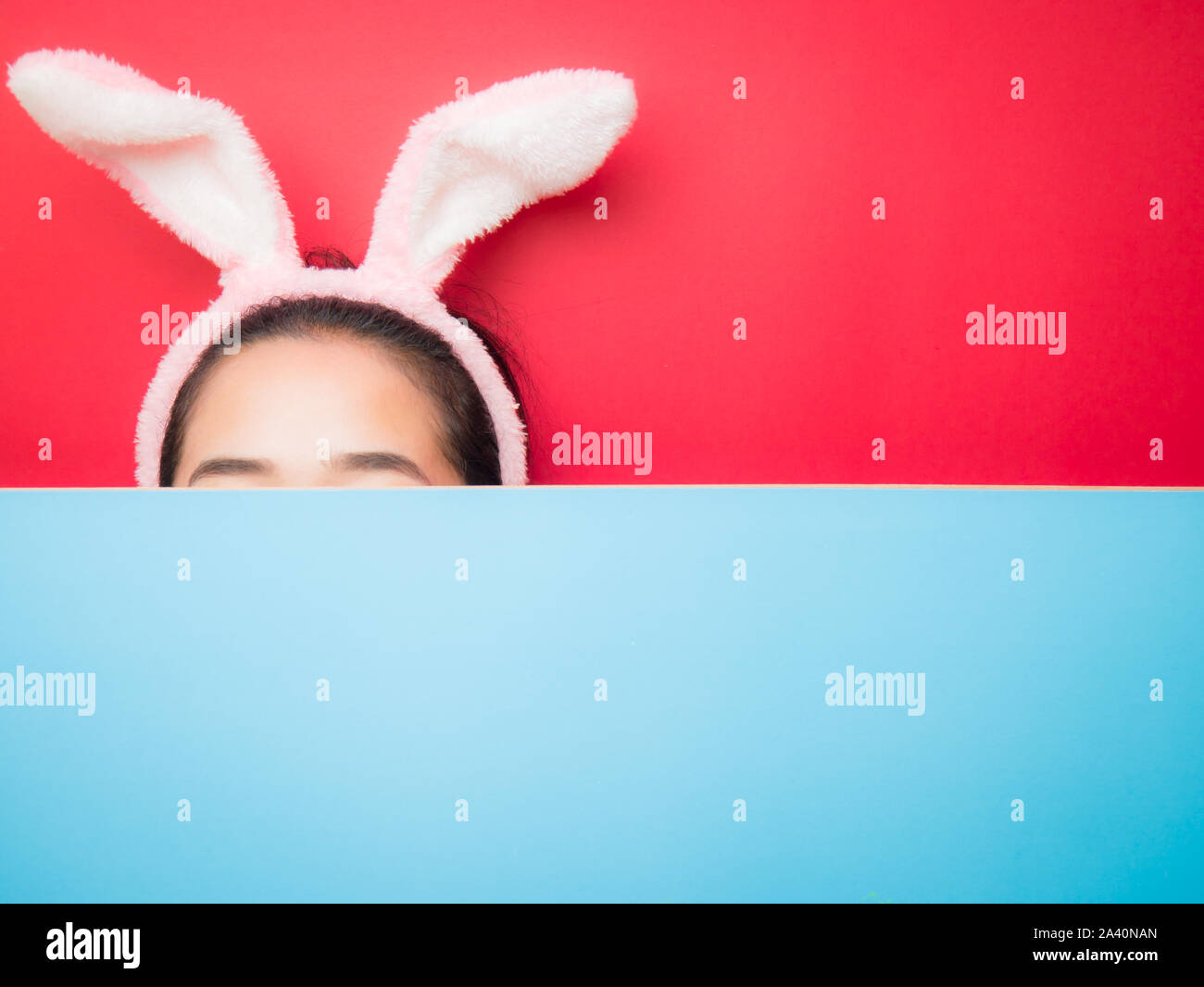 Cute Teenage Girl Wearing Bunny Ears Headband On Sky And Red Background