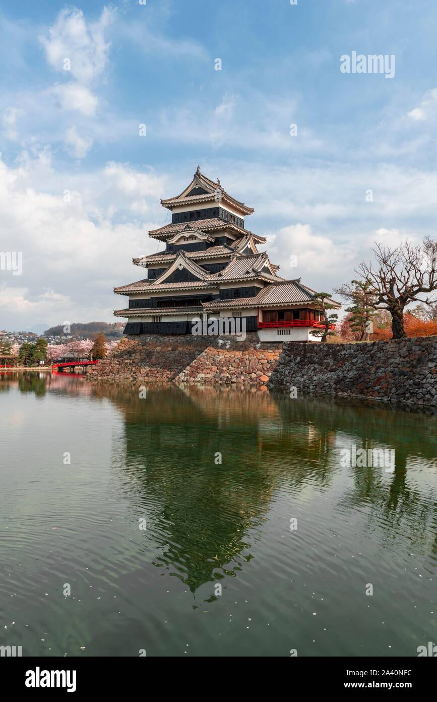 Old Japanese castle reflected in the moat, Matsumoto Castle, Matsumoto ...