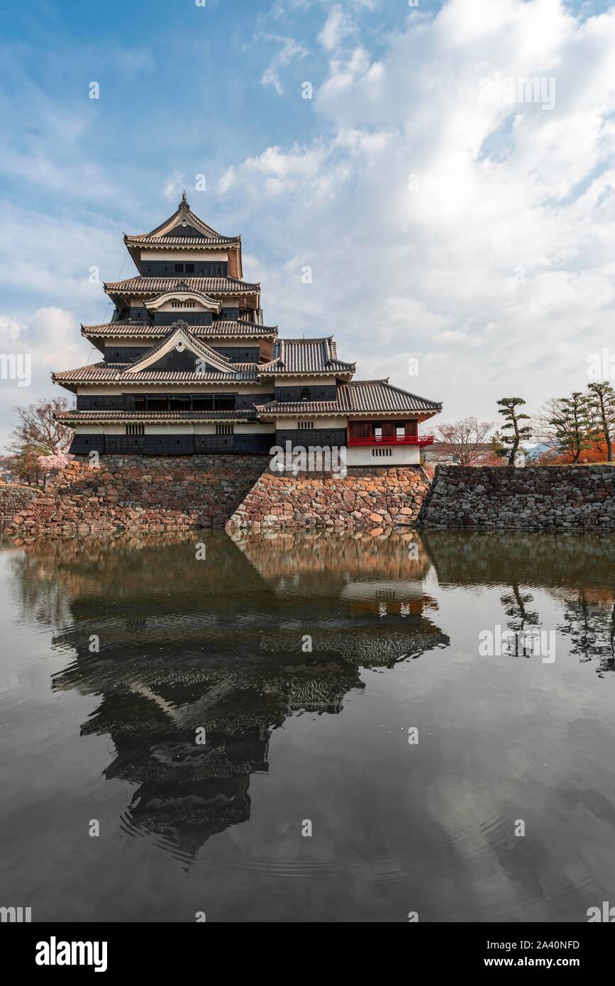 Old Japanese castle reflected in the moat, Matsumoto Castle, Matsumoto ...