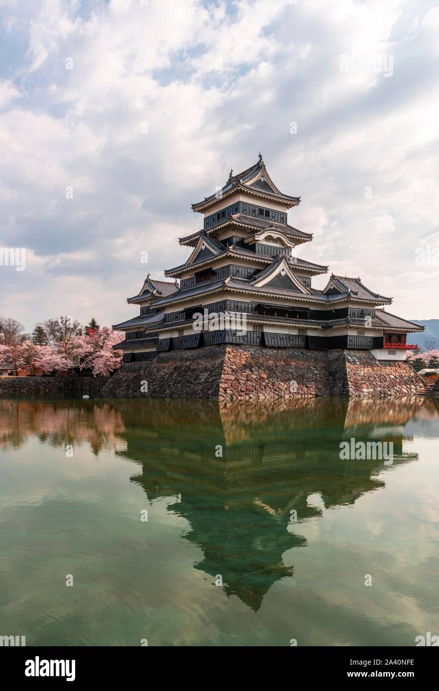 Old Japanese castle reflected in the moat, Matsumoto Castle, Matsumoto ...