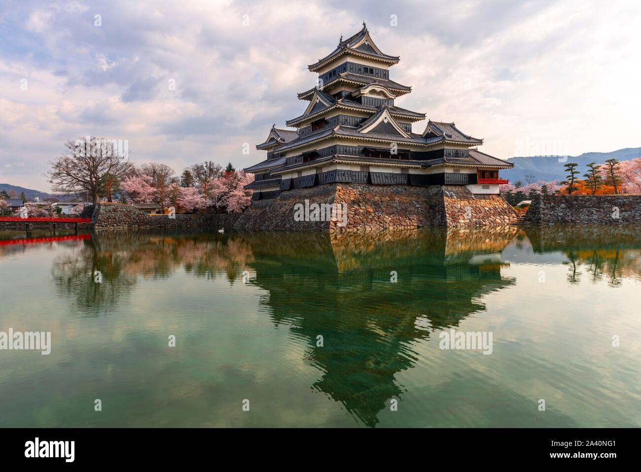 Old Japanese castle reflected in the moat, Matsumoto Castle, Matsumoto ...