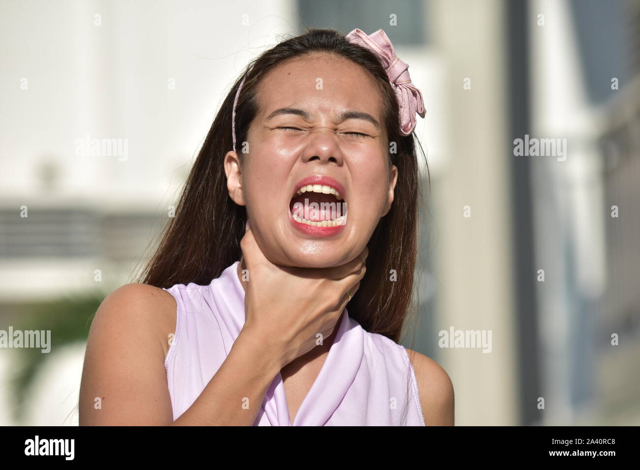 Beautiful Filipina Female Choking Stock Photo - Alamy