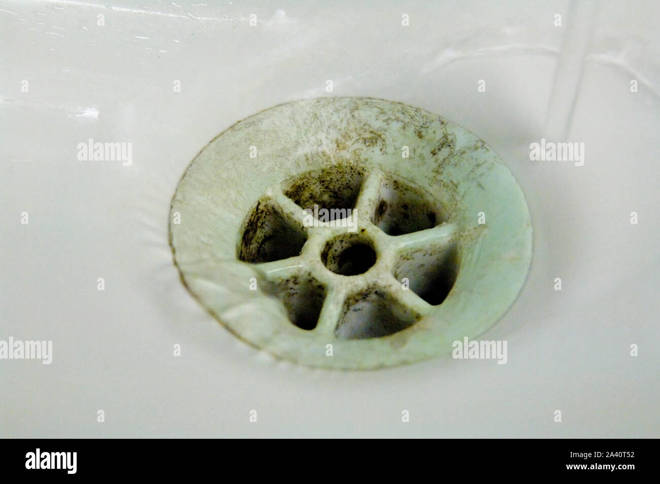 Dirty and disgusting bathroom sink with dirty plughole Stock Photo - Alamy