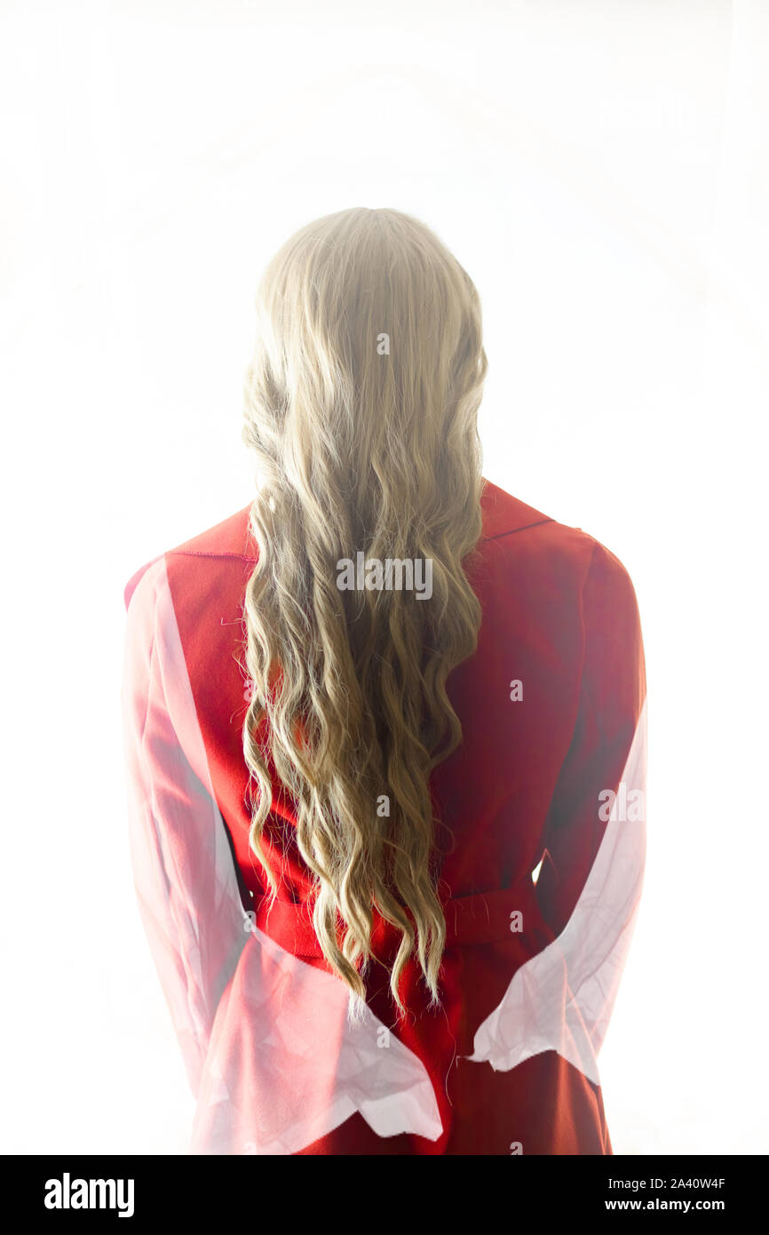 Blonde woman standing at window Stock Photo - Alamy