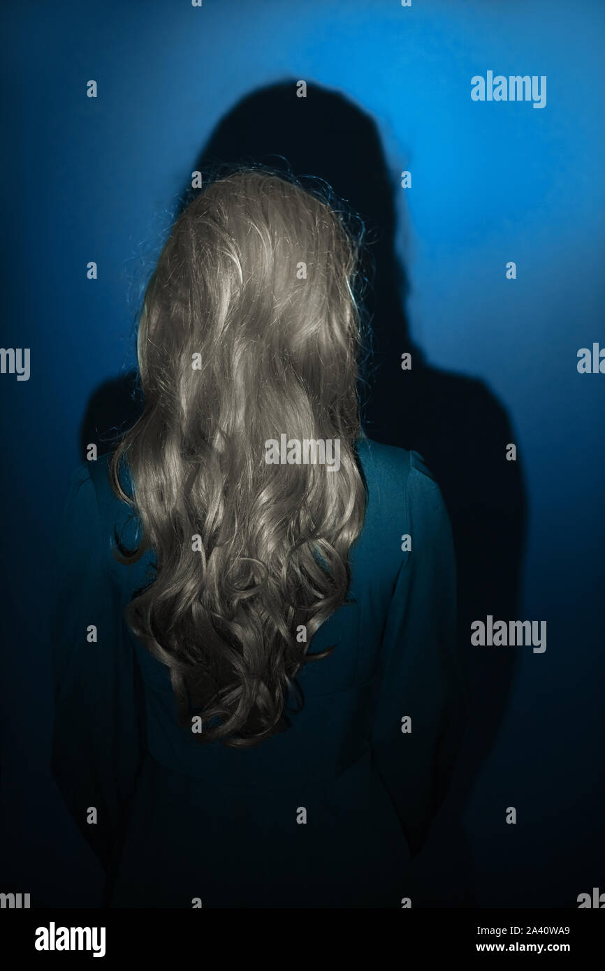 Blonde woman from behind in studio Stock Photo - Alamy