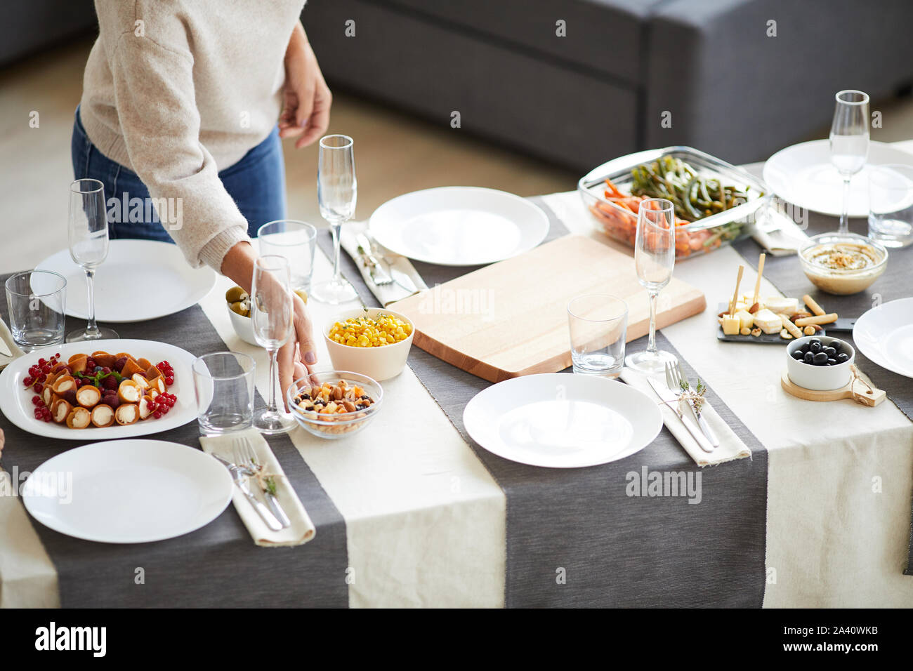 Close-up of woman putting the meal on the served table and preparing ...