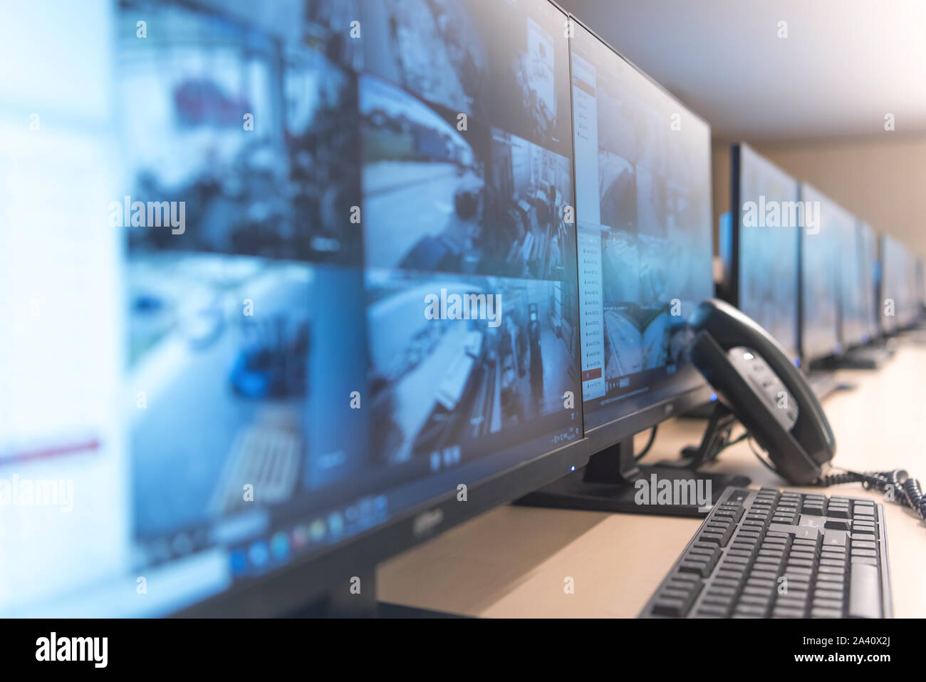 Security guard monitoring modern CCTV cameras in surveillance room ...