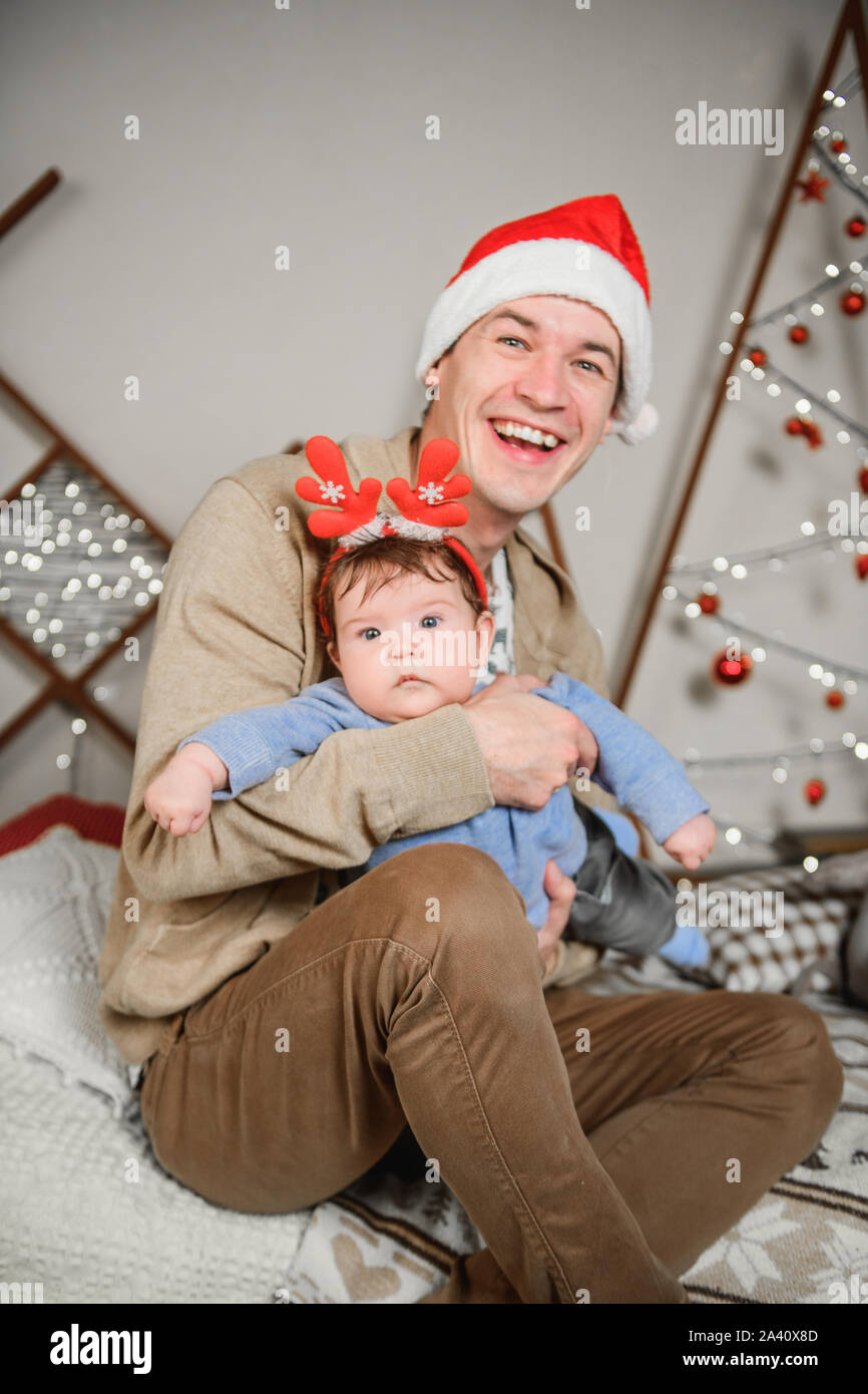 baby and father on christmas background. happy family father and child ...