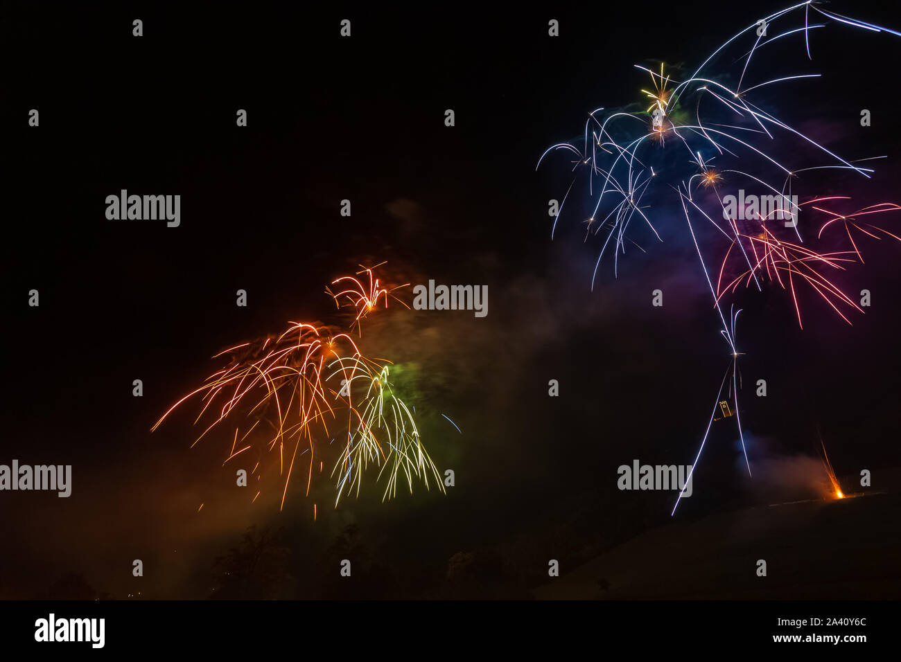 Falling and multi-colored fireworks above a illuminated church Stock ...