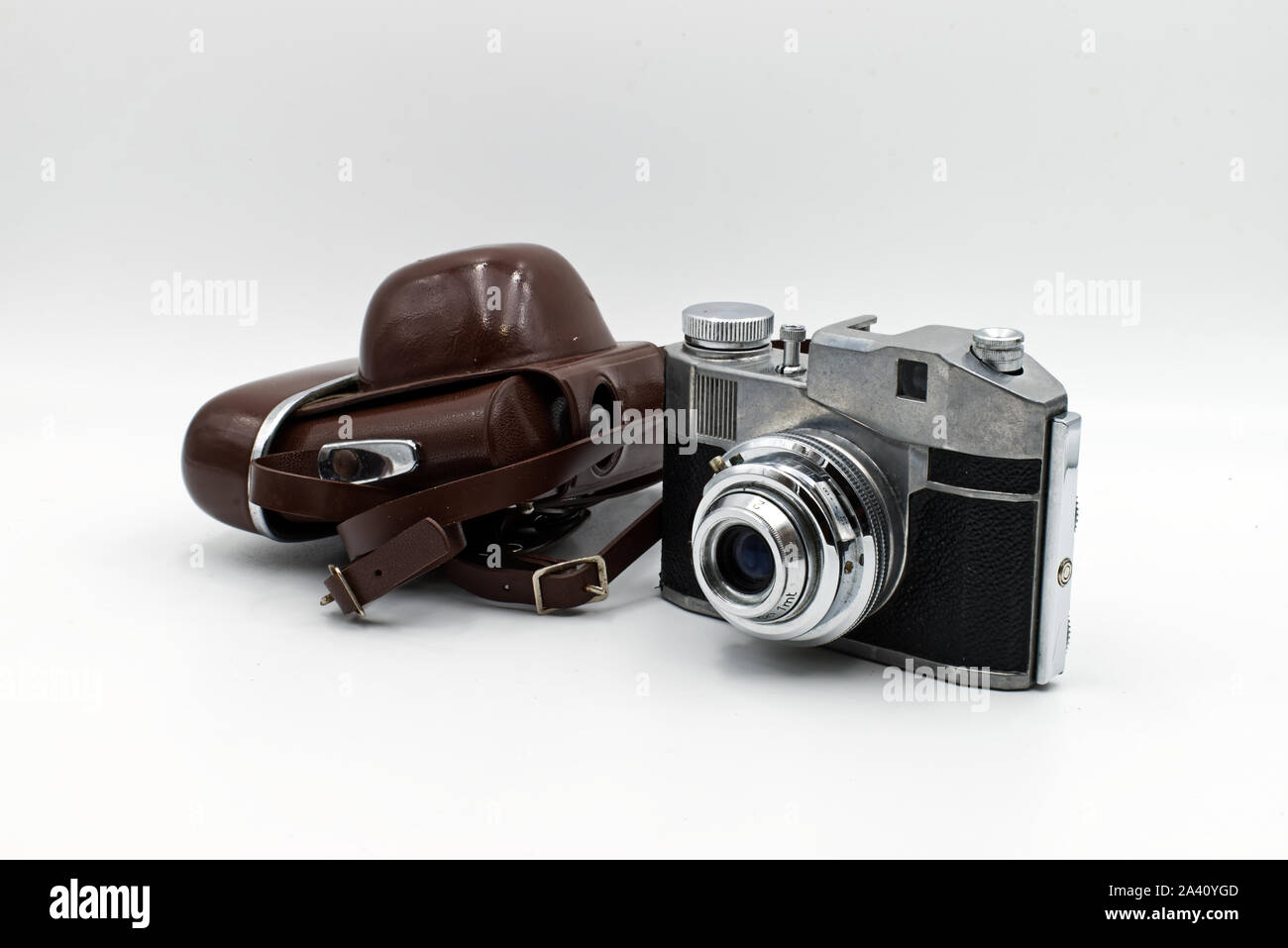 Ancient camera with its leather bag cover, isolated on white background ...