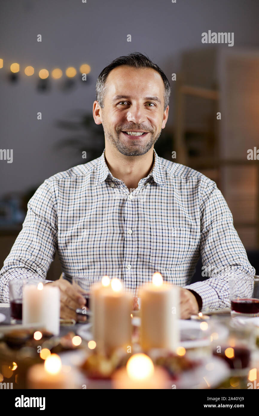 Portrait of young man smiling at camera while have dinner at dining ...