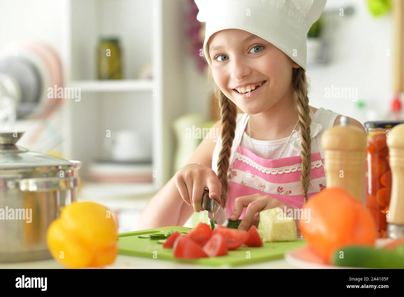 Cute girl cooking on kitchen and listening to music Stock Photo - Alamy