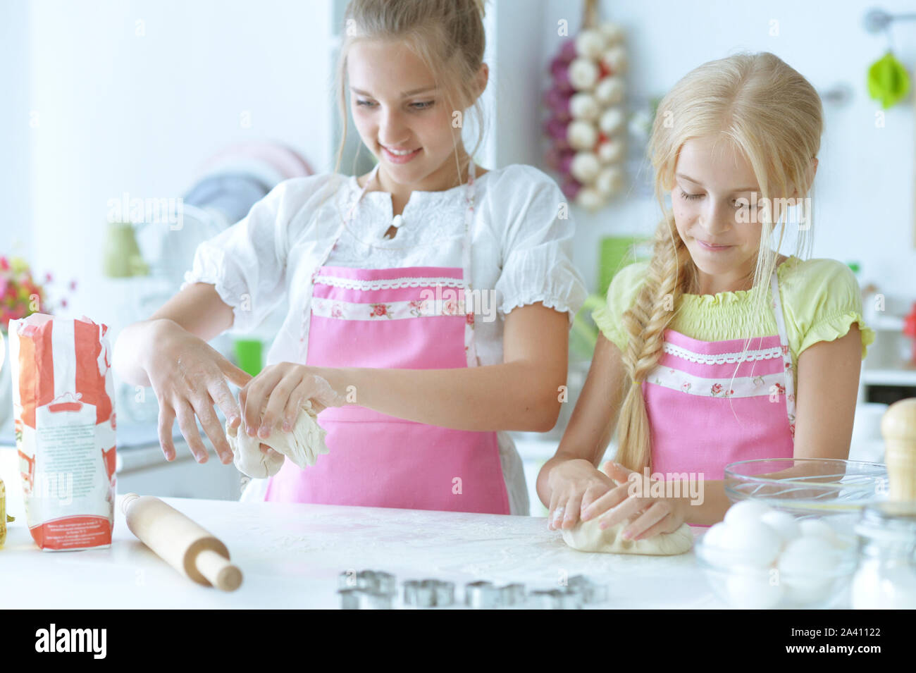 Cute girls baking in the kitchen at home Stock Photo - Alamy