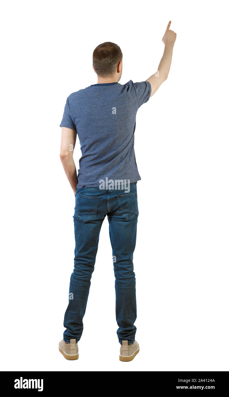 Back view of a man in jeans points his hand upwards. Rear view people ...