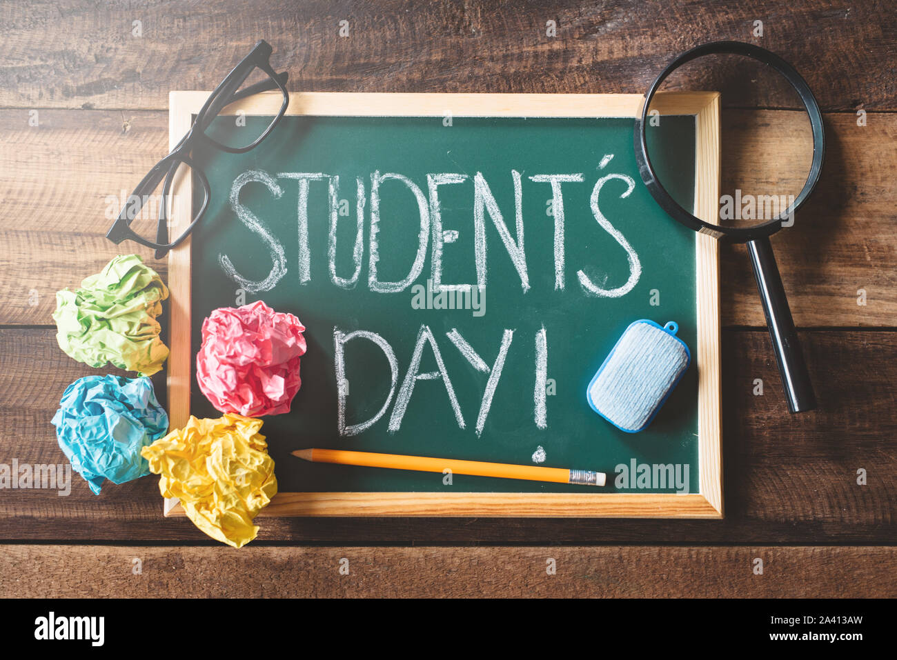 green chalkboard with handwritten STUDENT'S DAY word on wooden table ...