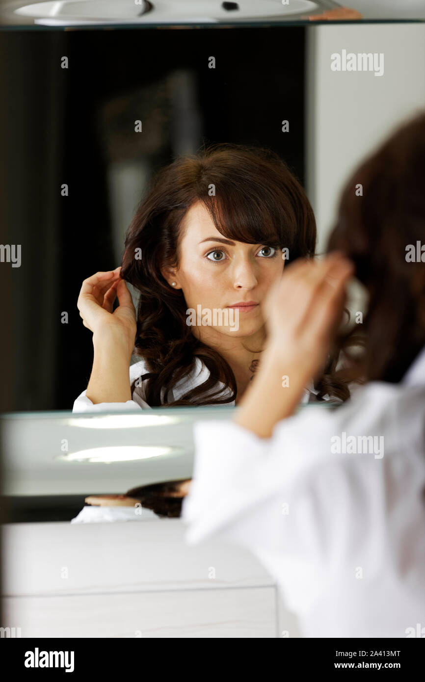 Beautiful young woman getting ready in her bathroom Stock Photo - Alamy