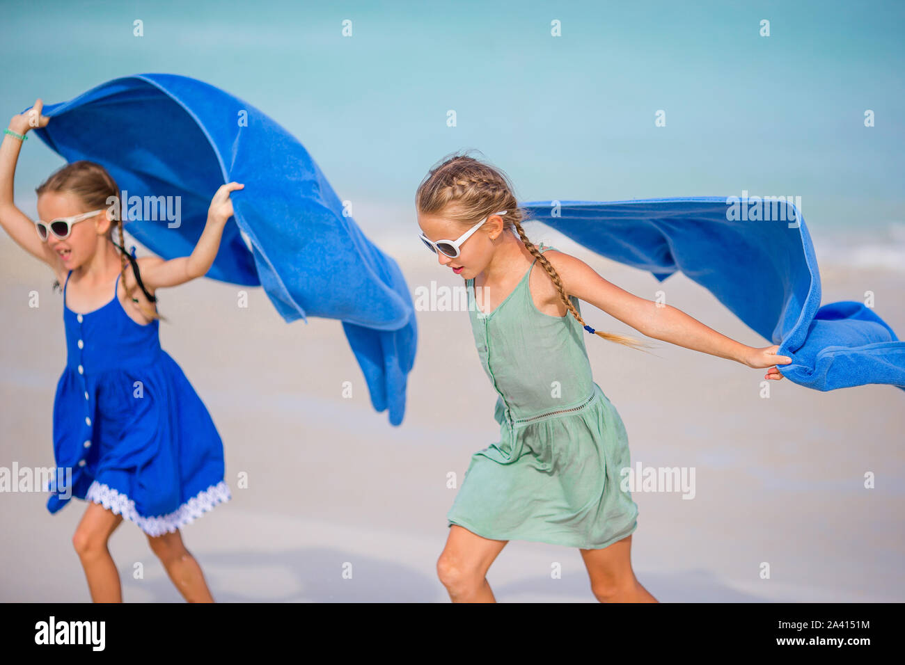 Little girls fooling around on the beach on summer vacation Stock Photo ...