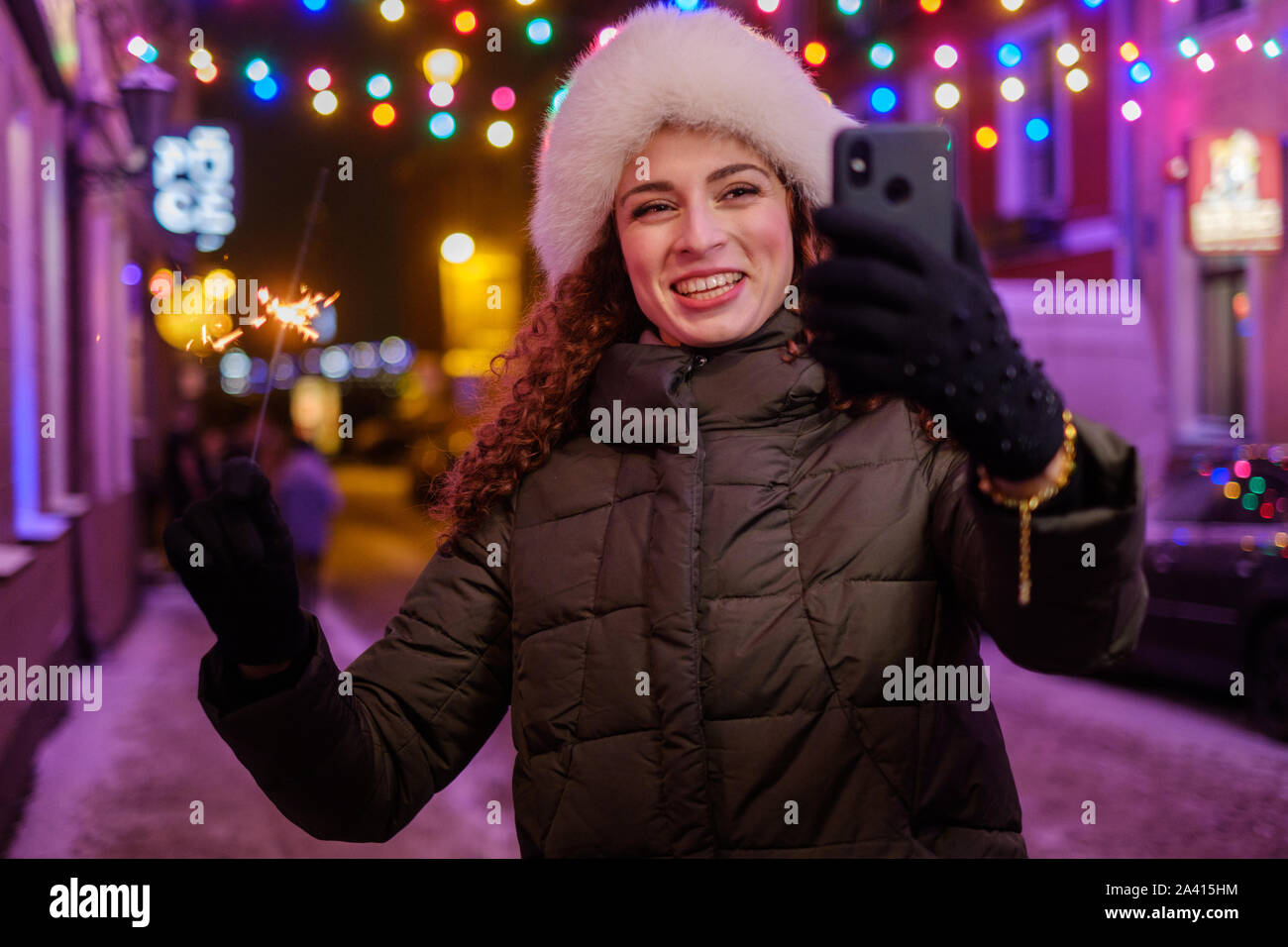 Woman making video call on a cold winter evening Stock Photo - Alamy