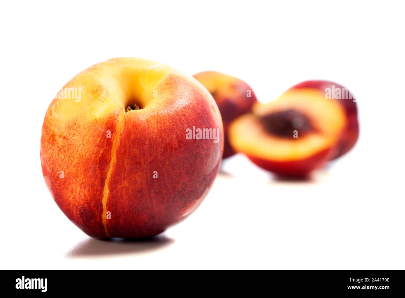 Whole and sliced fresh ripe Nectarines on an isolated background Stock ...