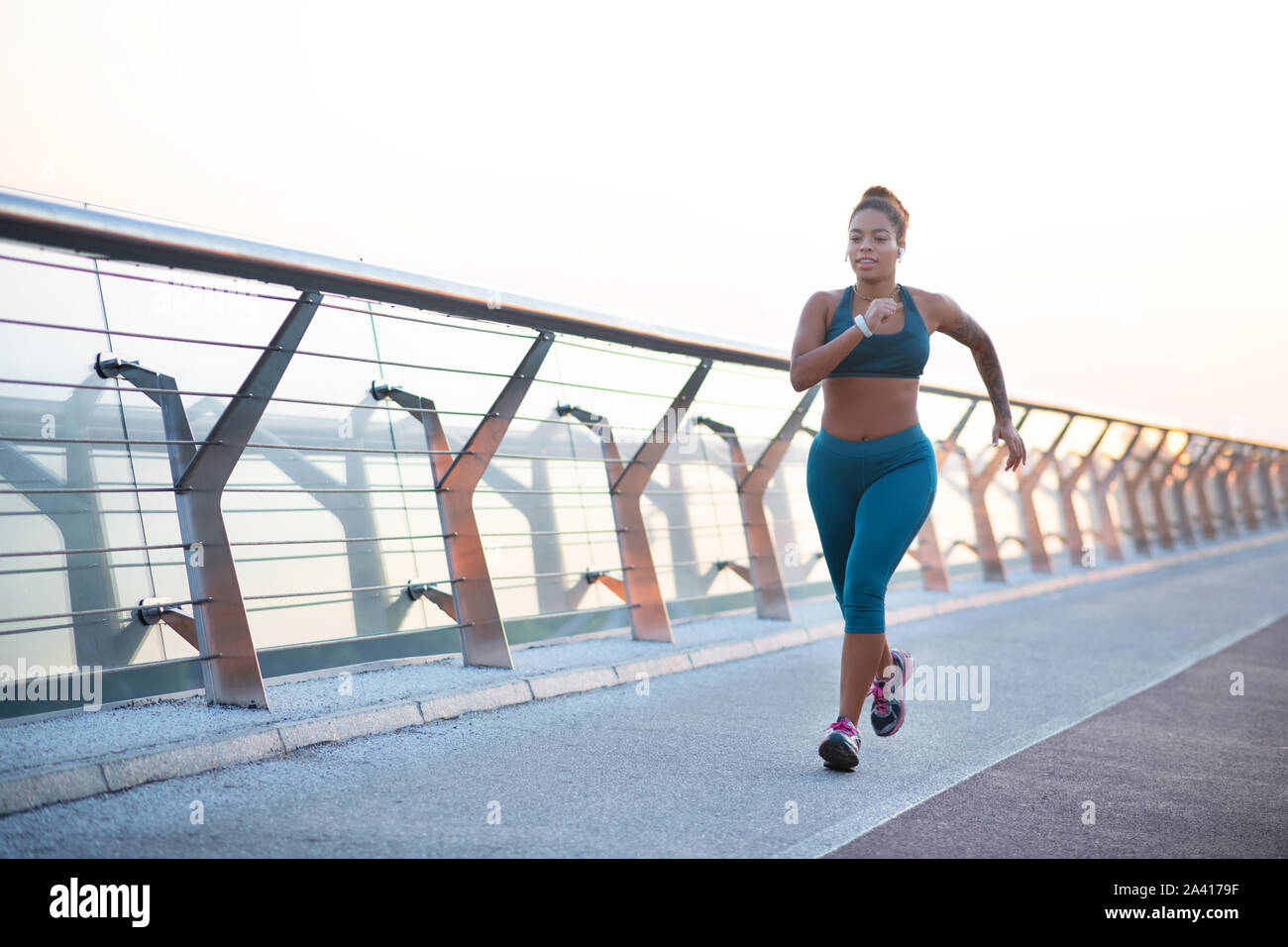 Dark-skinned young overweight woman running really fast Stock Photo - Alamy