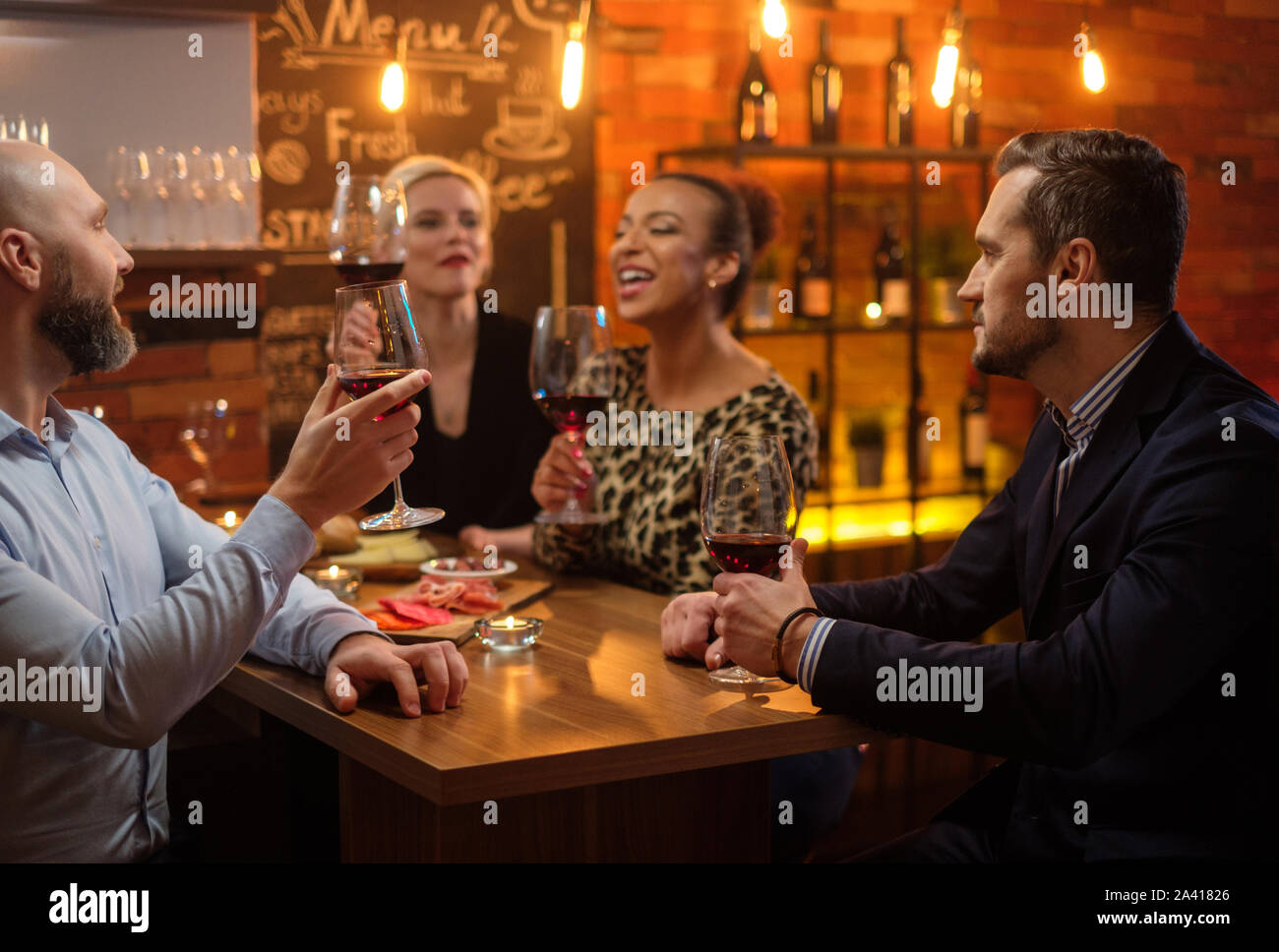 Group of friends having fun talk behind bar counter in a cafe Stock ...