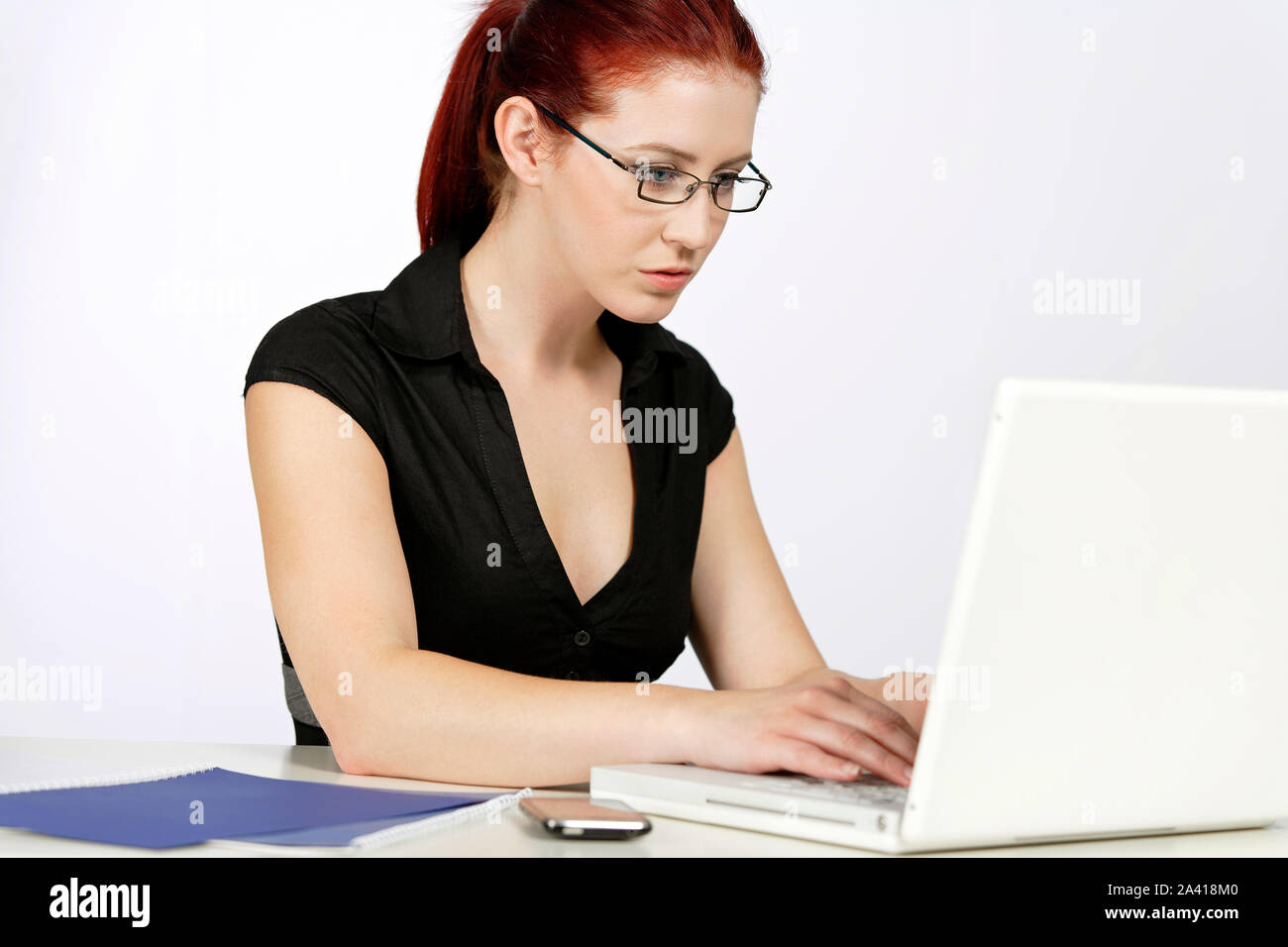 Professional woman showing concern at work using her laptop Stock Photo ...