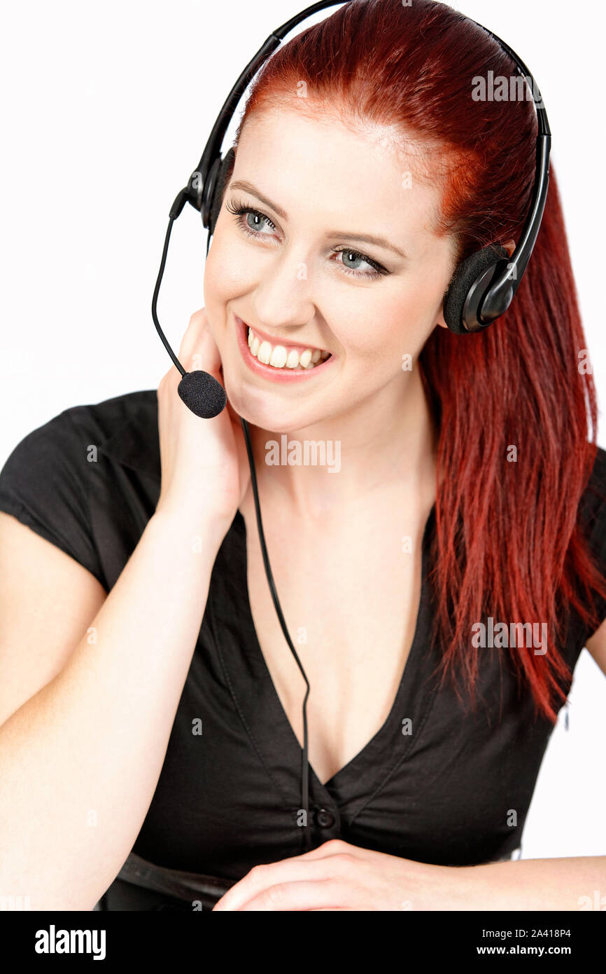 Professional woman talking on a headset in her office at work. With ...