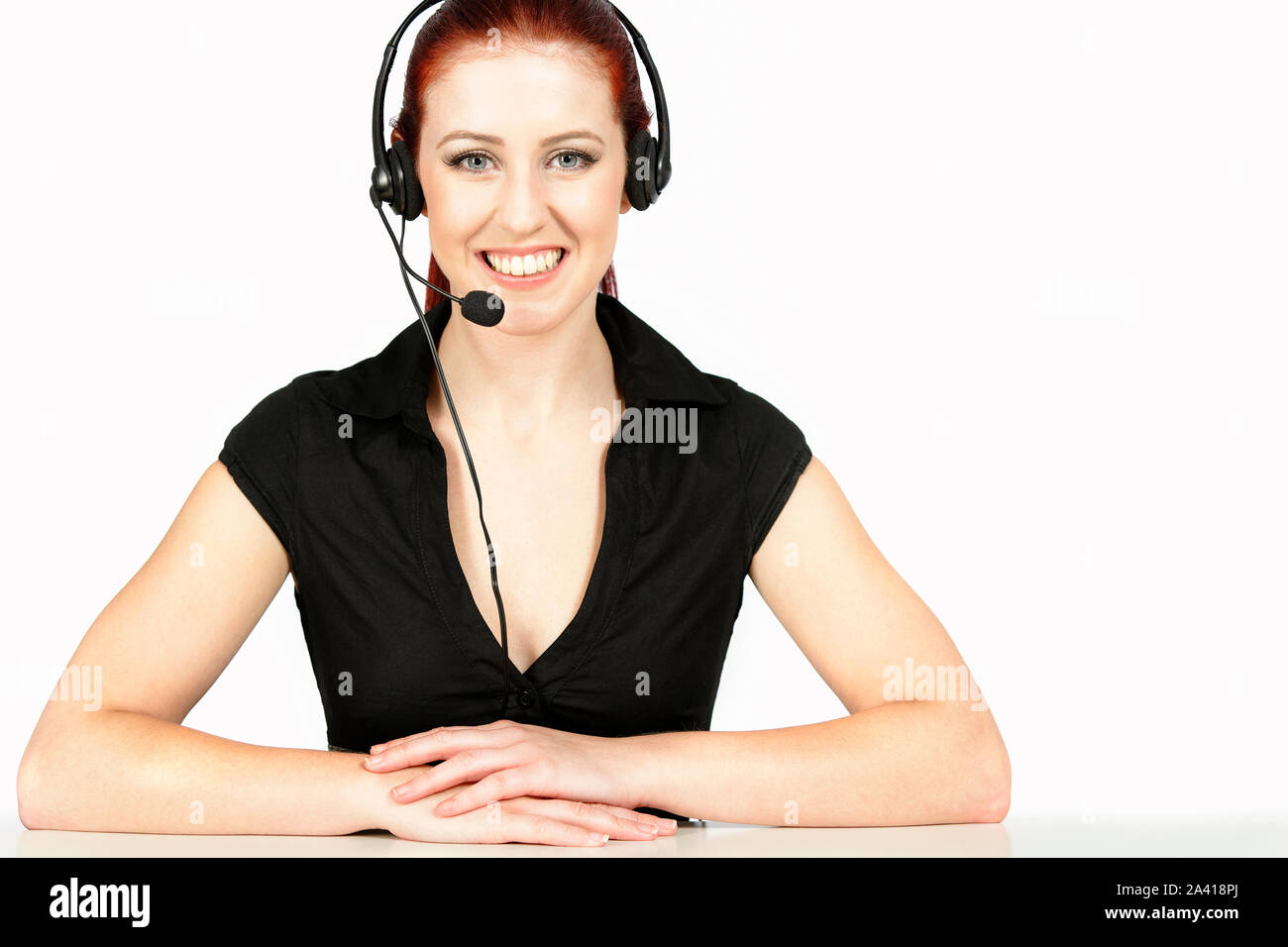 Professional woman talking on a headset in her office at work. With ...
