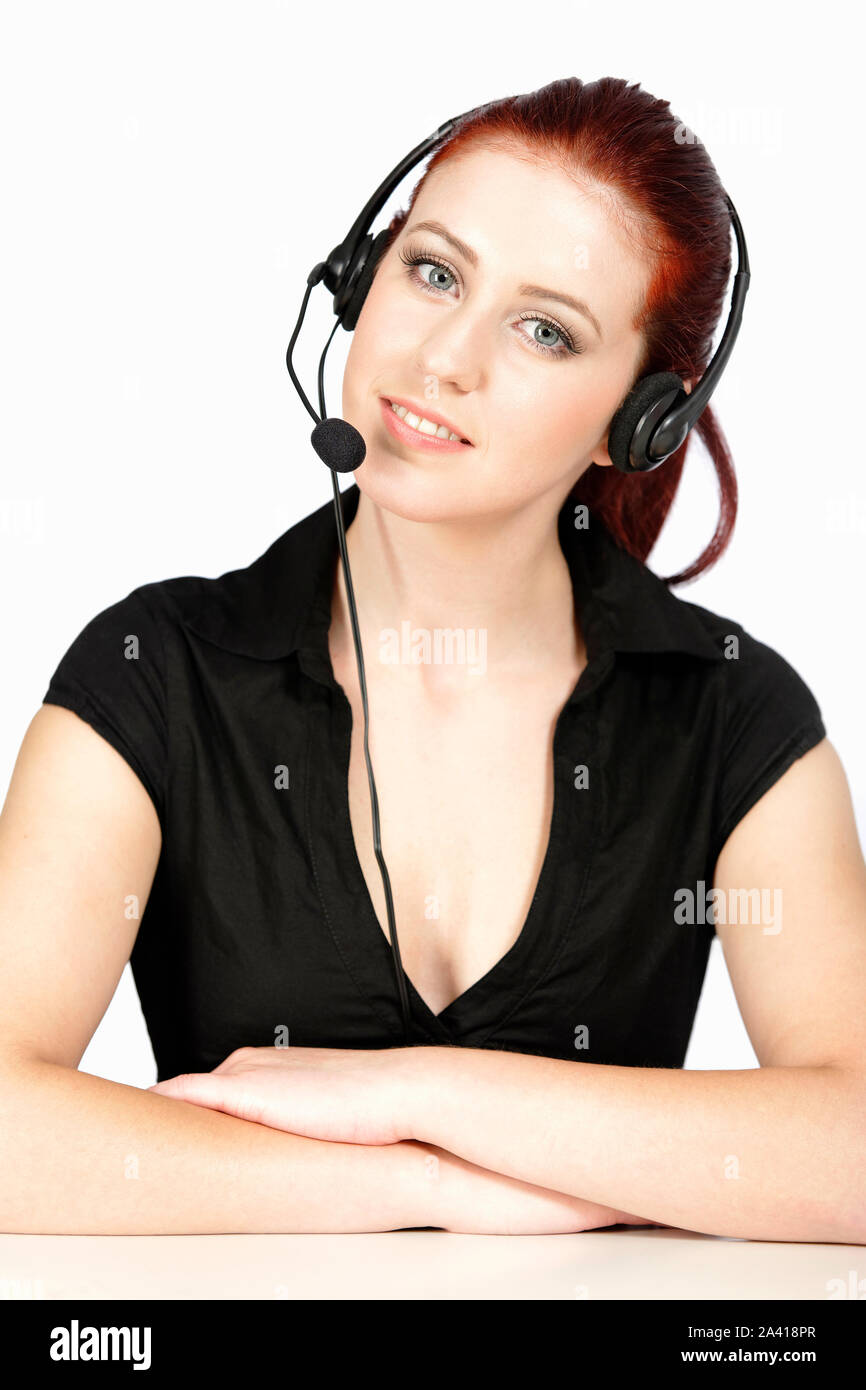 Professional woman talking on a headset in her office at work. With ...