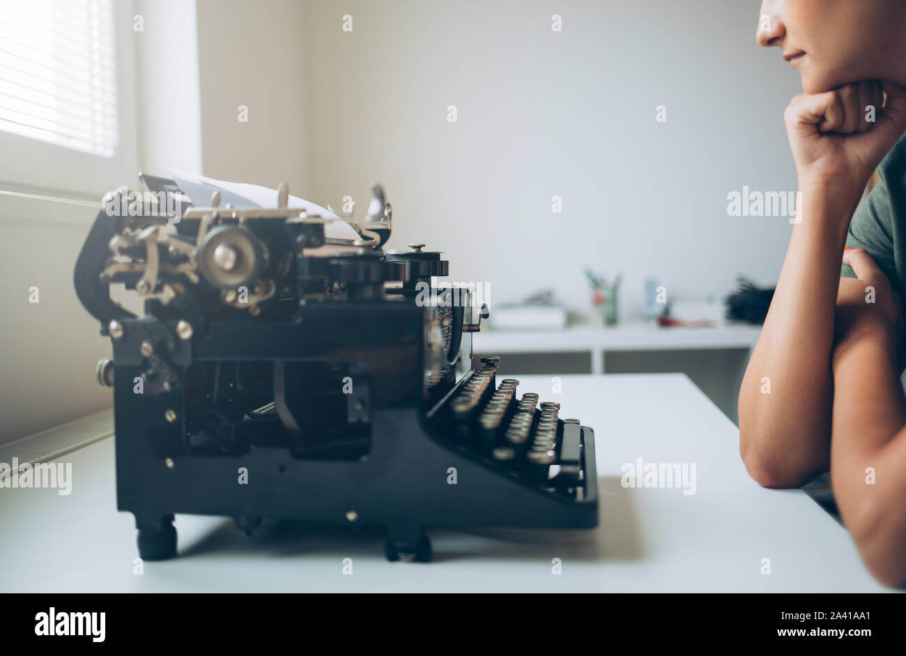 Female writer thinking on writer's desk Stock Photo - Alamy