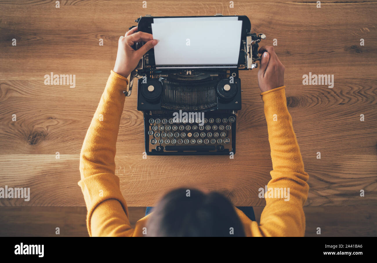 Close up of writer setting up typing machine Stock Photo - Alamy