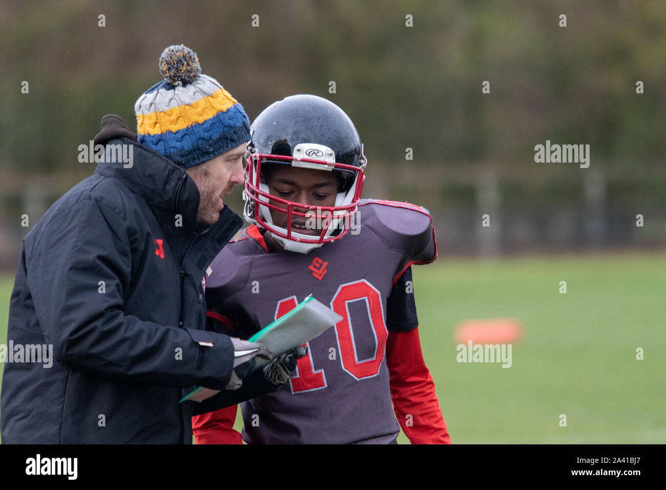 American football coach instructing player Stock Photo - Alamy