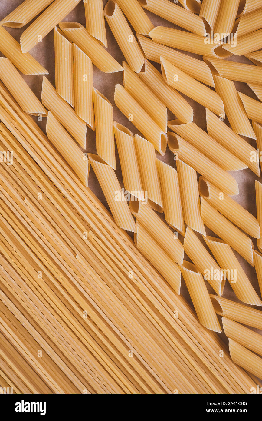 Raw spaghetti on brown parchment, paper background. Close-up pasta, top ...