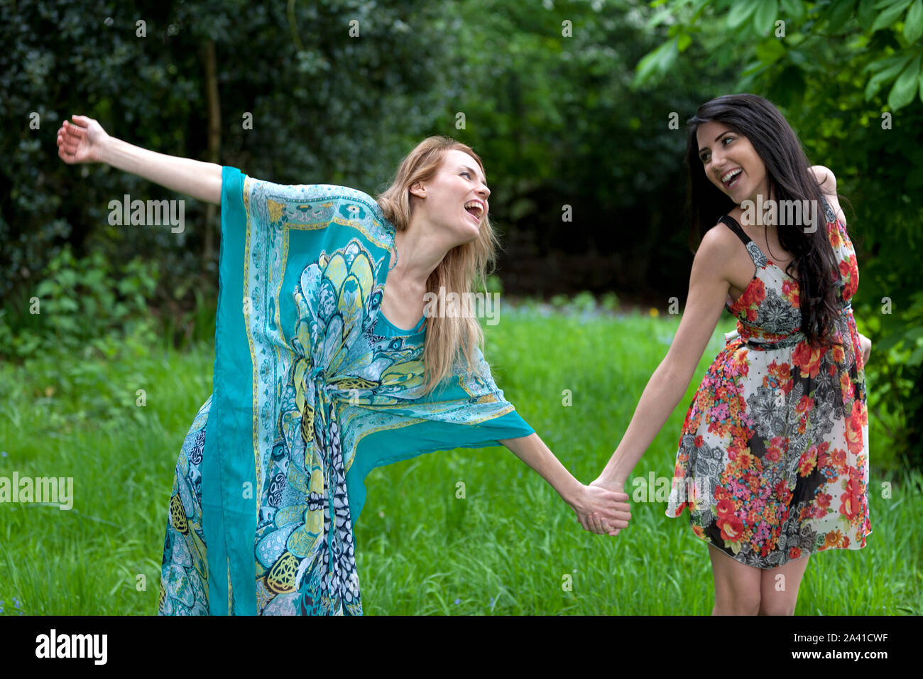 Two friends messing around in a field in summer time Stock Photo - Alamy