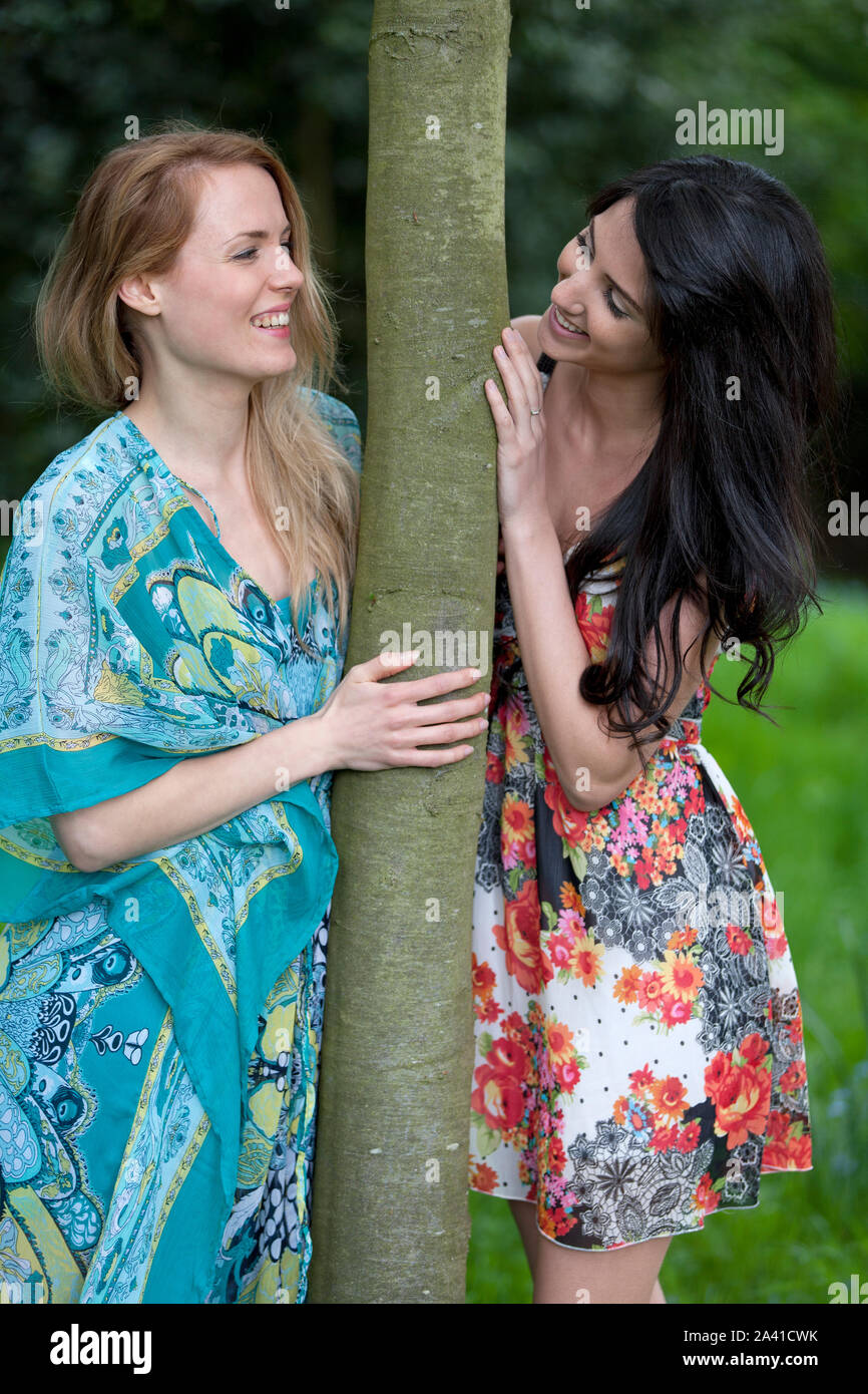 Two friends messing around in a field in summer time Stock Photo - Alamy
