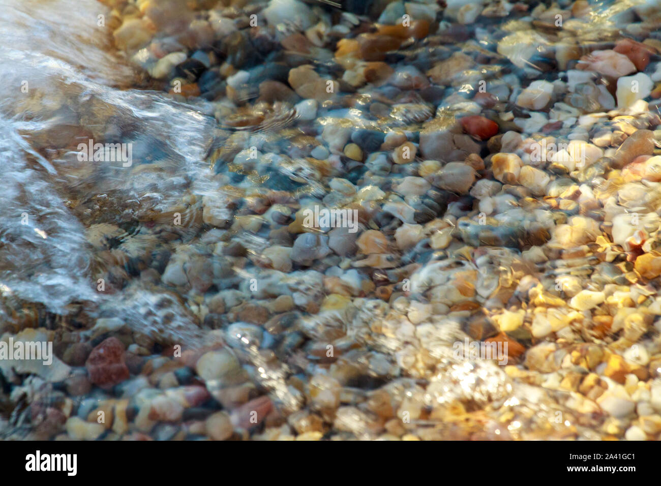 sea pebbles colored granite on the beach background stones. The shore ...