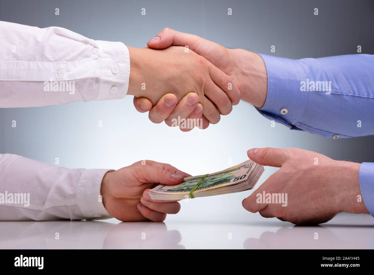 Close-up Of Businessmen Sealing The Deal With Handshake And Receiving A ...