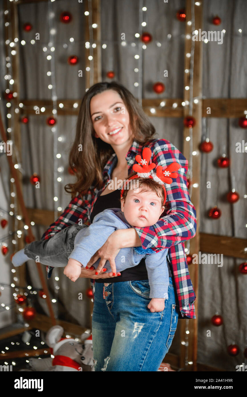 Baby with mother at Christmas. happy family mother and baby little son ...