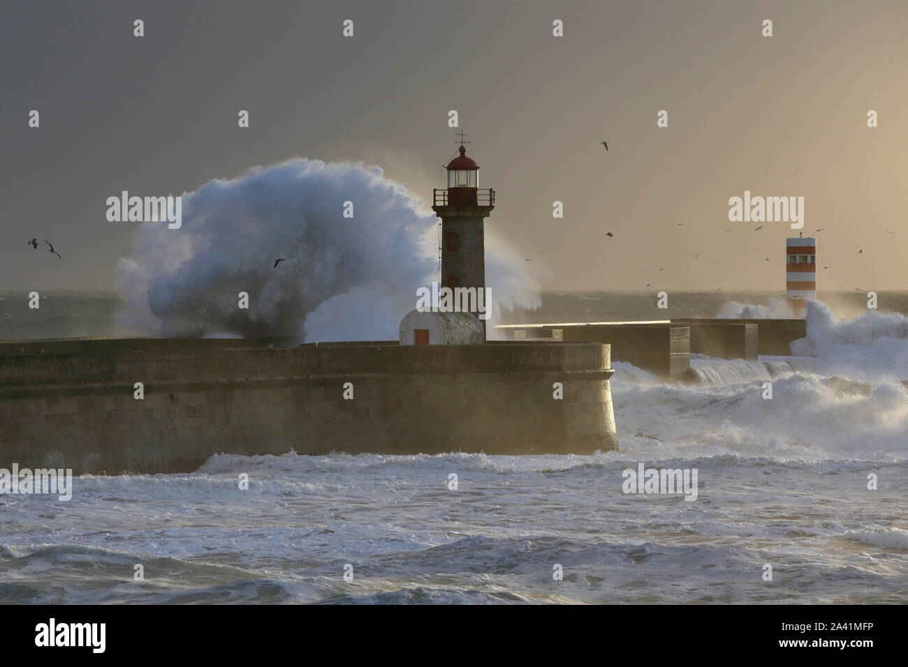 Big stormy breaking waves over Douro river mouth piers and beacons at ...