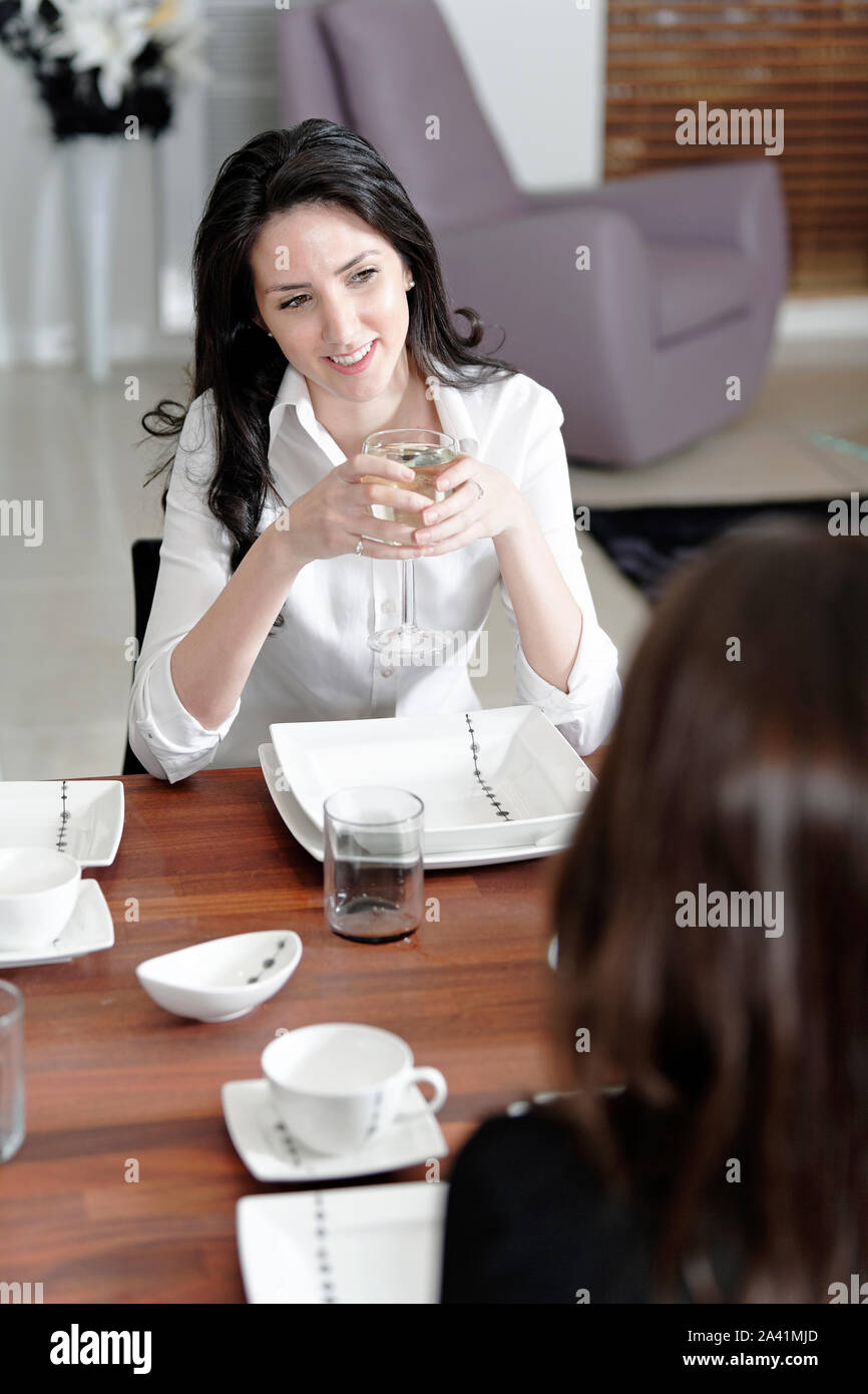 Tow attractive friends at a dinner party having fun Stock Photo - Alamy